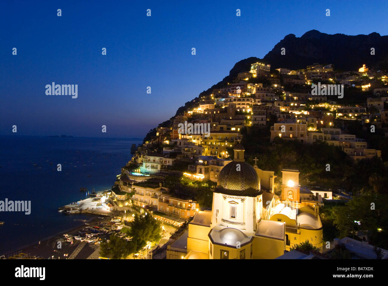 the lights of the town of Positano Italy on the Amalfi coast at sunset ...