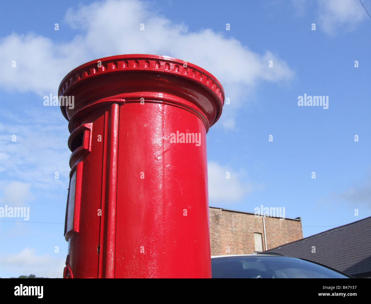 red royal mail letter box in wales and blue sky Stock Photo - Alamy