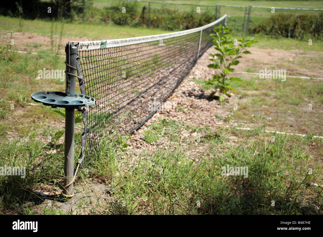 Old weedy and unused clay tennis court Stock Photo - Alamy