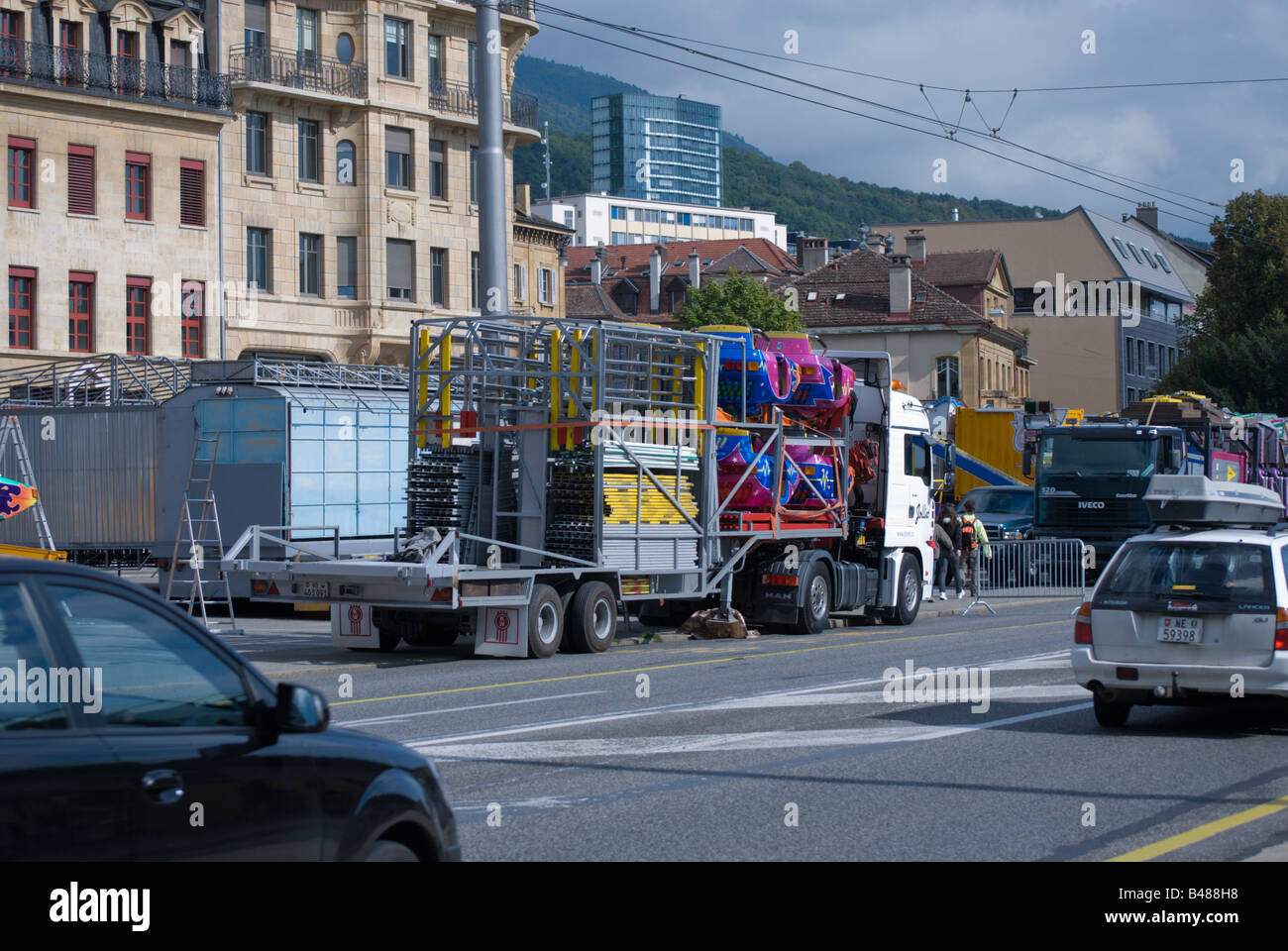 A carnival ride arrives in town. The truck is in the process of placing ...