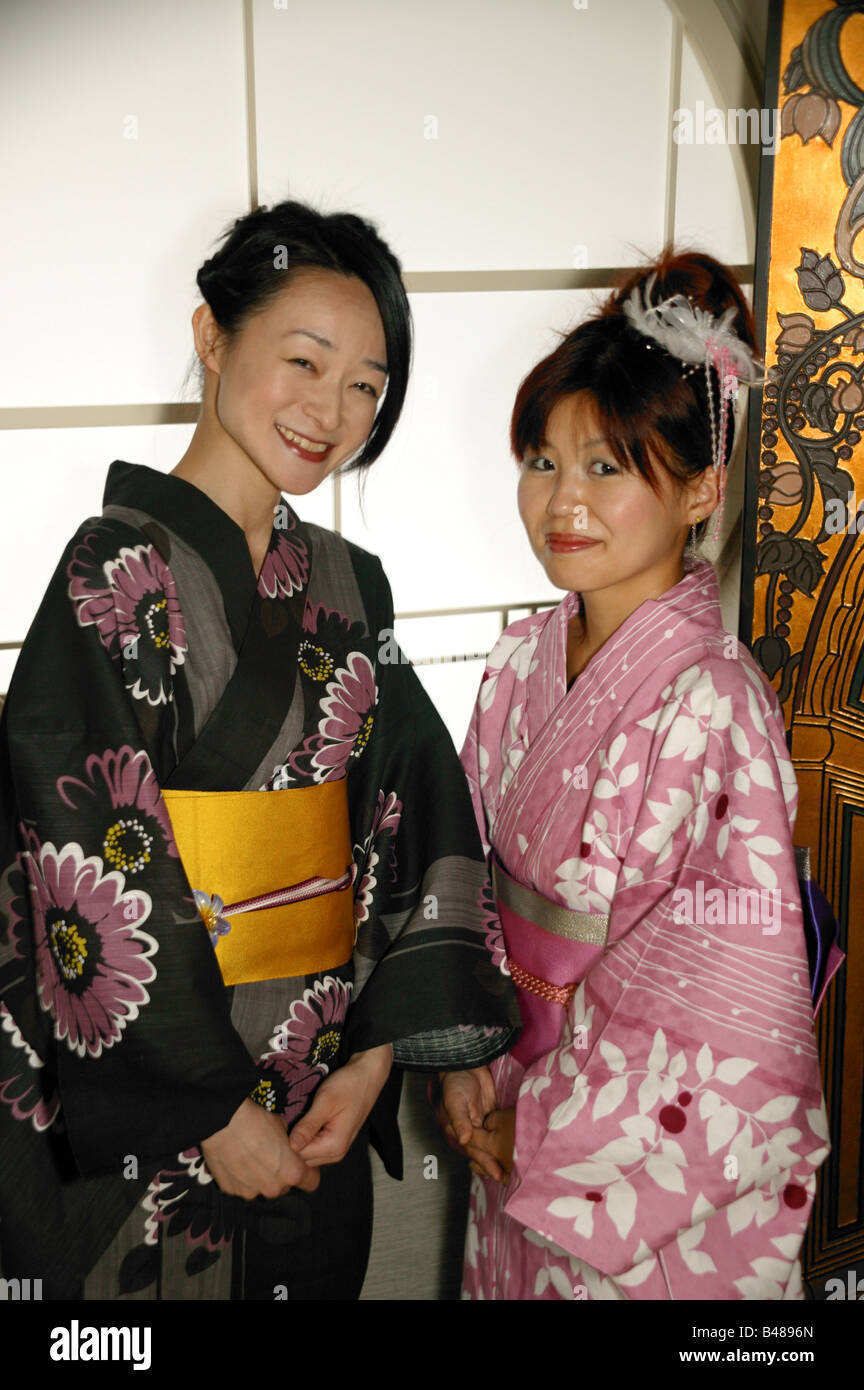 Two Japanese girls wearing traditional kimonos indoors Stock Photo - Alamy