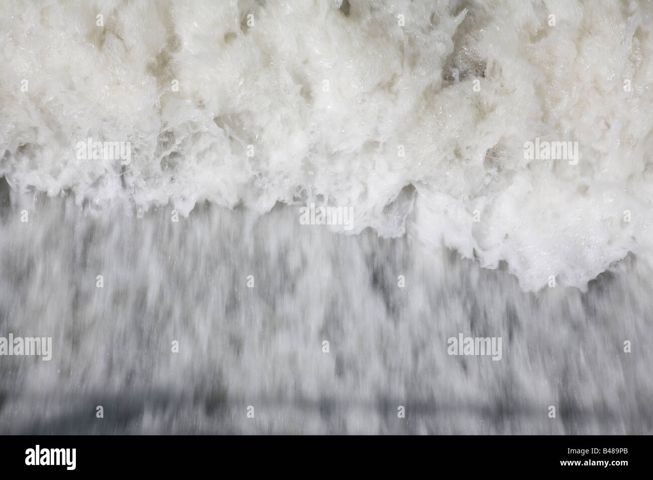 Flood water flowing over a weir, Guildford, Surrey, England Stock Photo ...