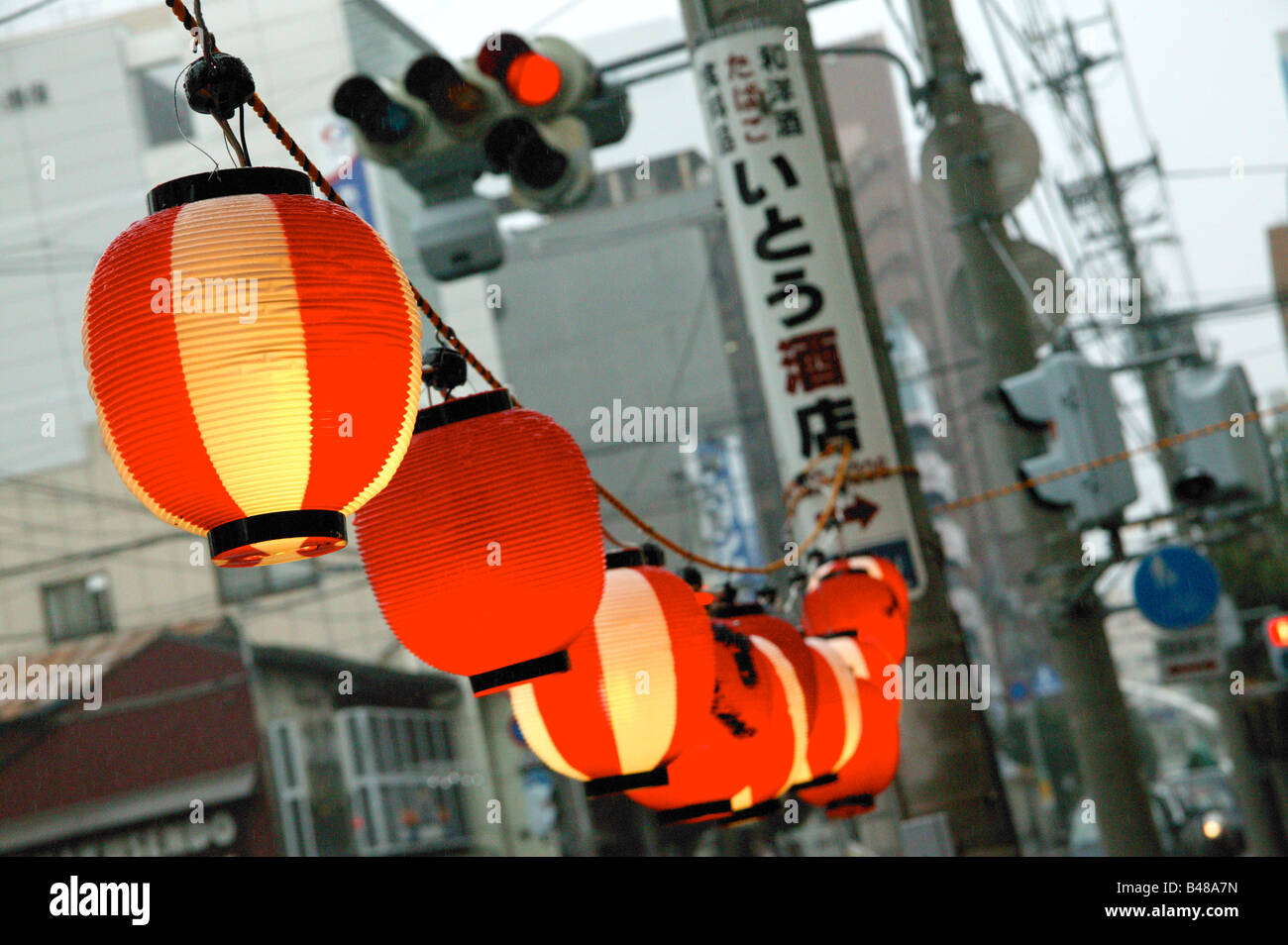 Street lanterns hung over a city street for a festival in Japan Stock ...