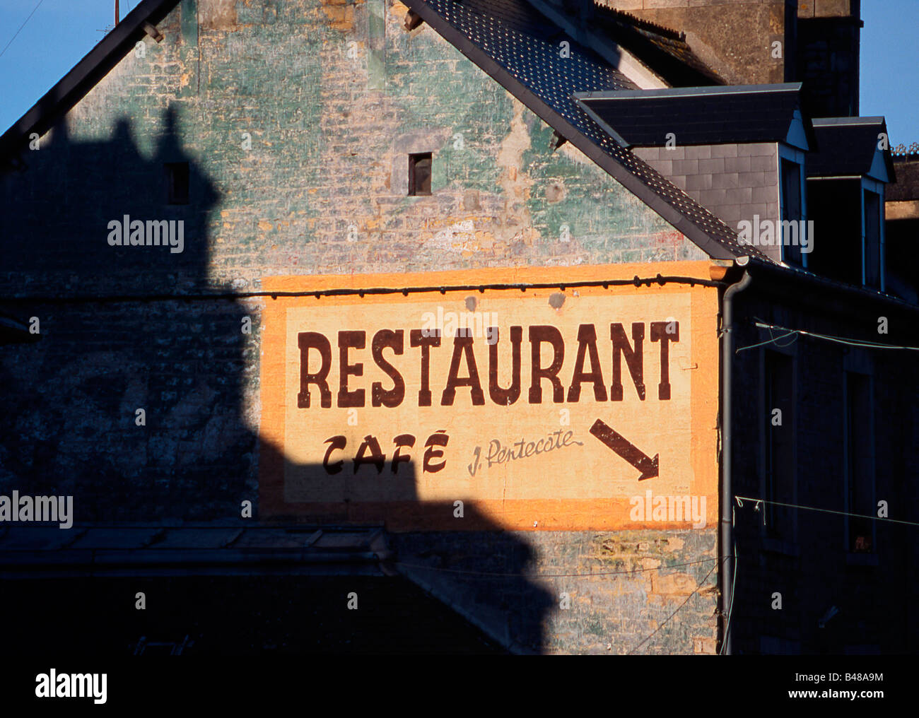 Restaurant sign on the side of a building Stock Photo - Alamy