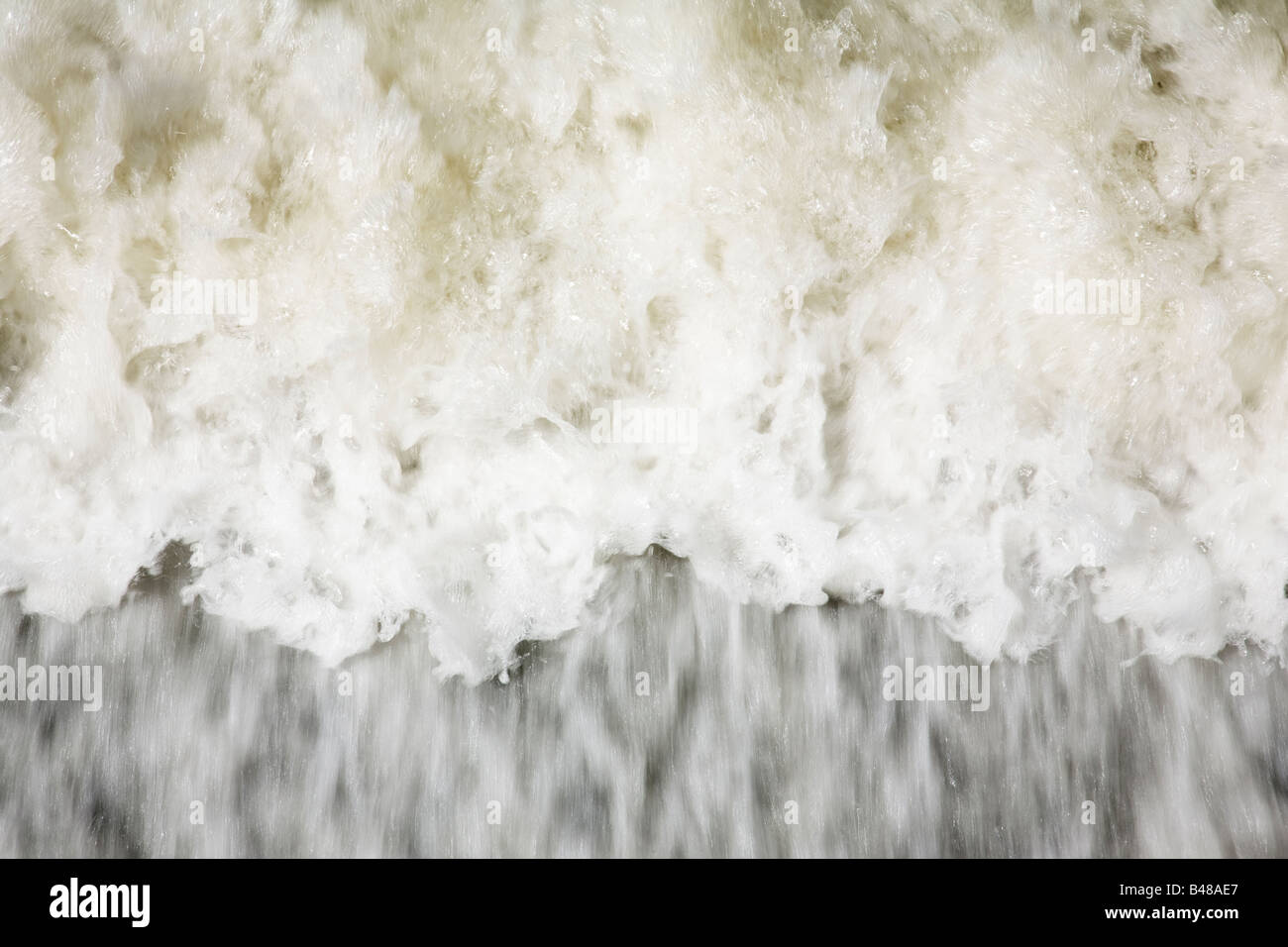 Flood water flowing over a weir, Guildford, Surrey, England Stock Photo ...