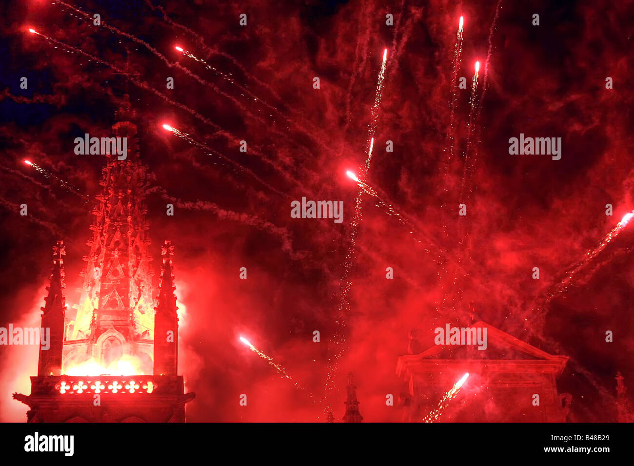 intense red fireworks on a Christian church with dense smoke, patrick ...