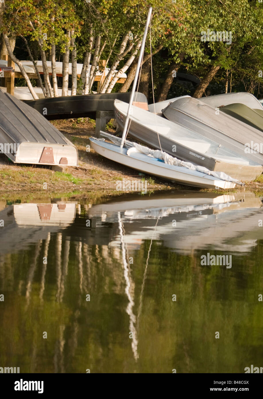 Boats on the shore of a lake Stock Photo - Alamy