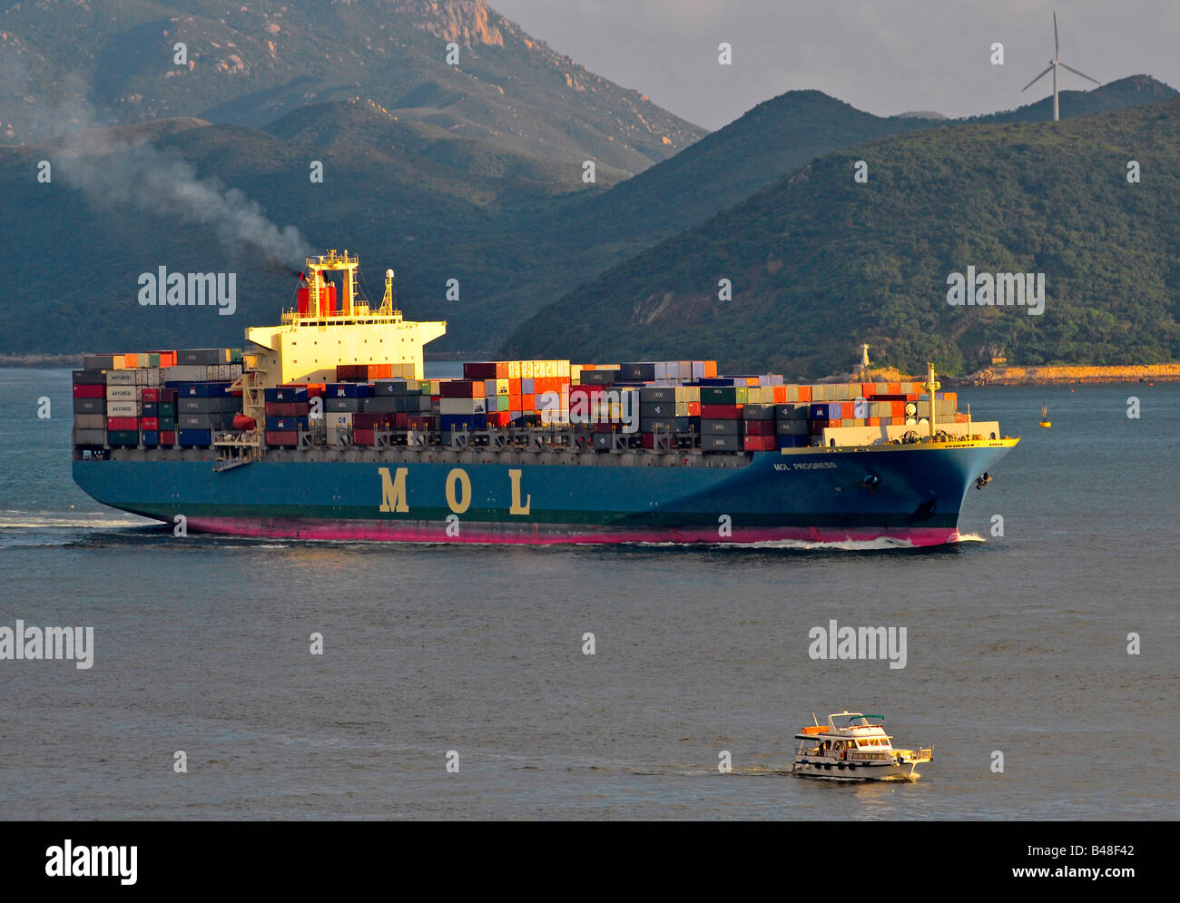 Container ships transporting cargo into Hong Kong from mainland China ...