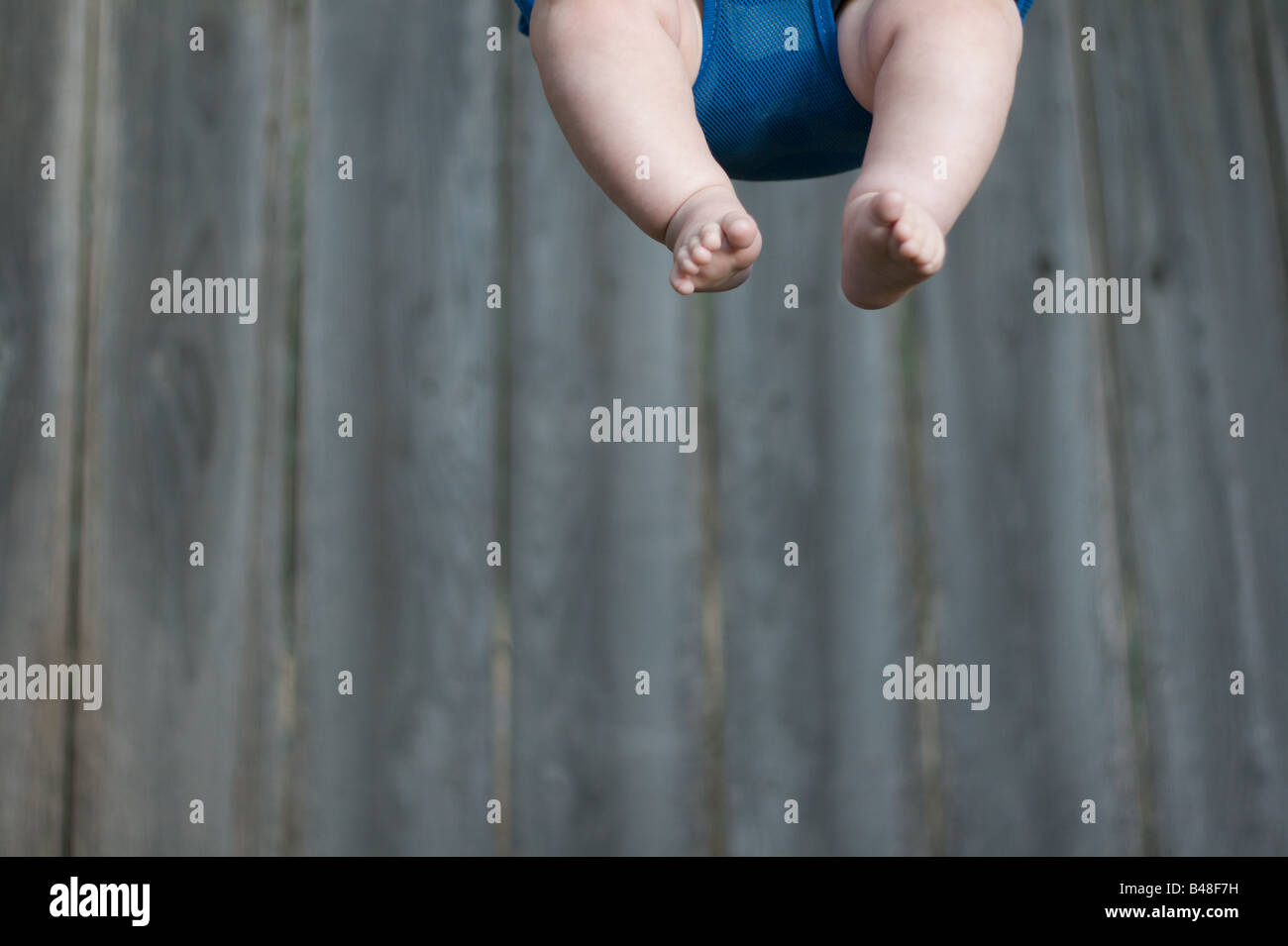 A babys toes dangling from a swing Stock Photo - Alamy