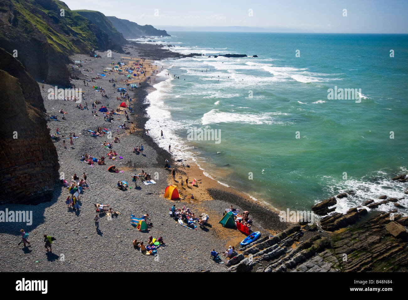 Tourists enjoying the sun on August bank holiday at Sandymouth beach in ...