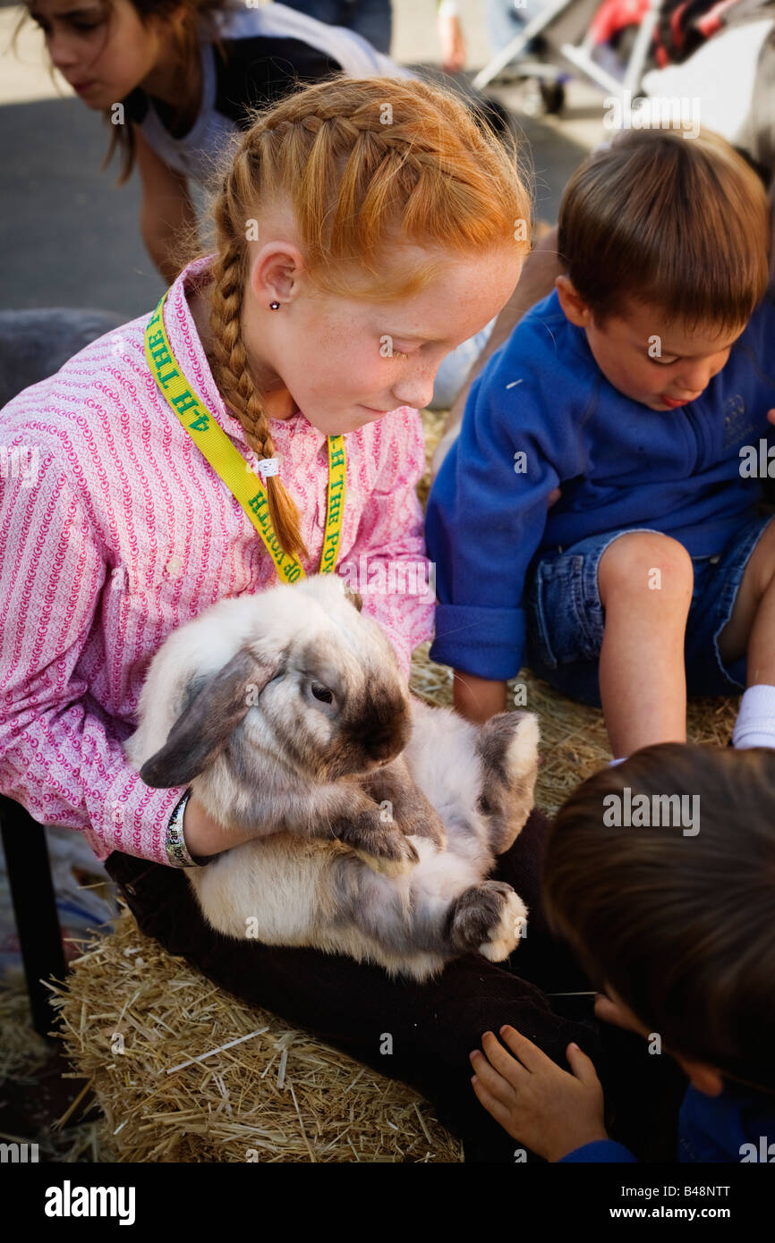 A young girl proudly shows her prize rabbit to children at the 2007 San ...