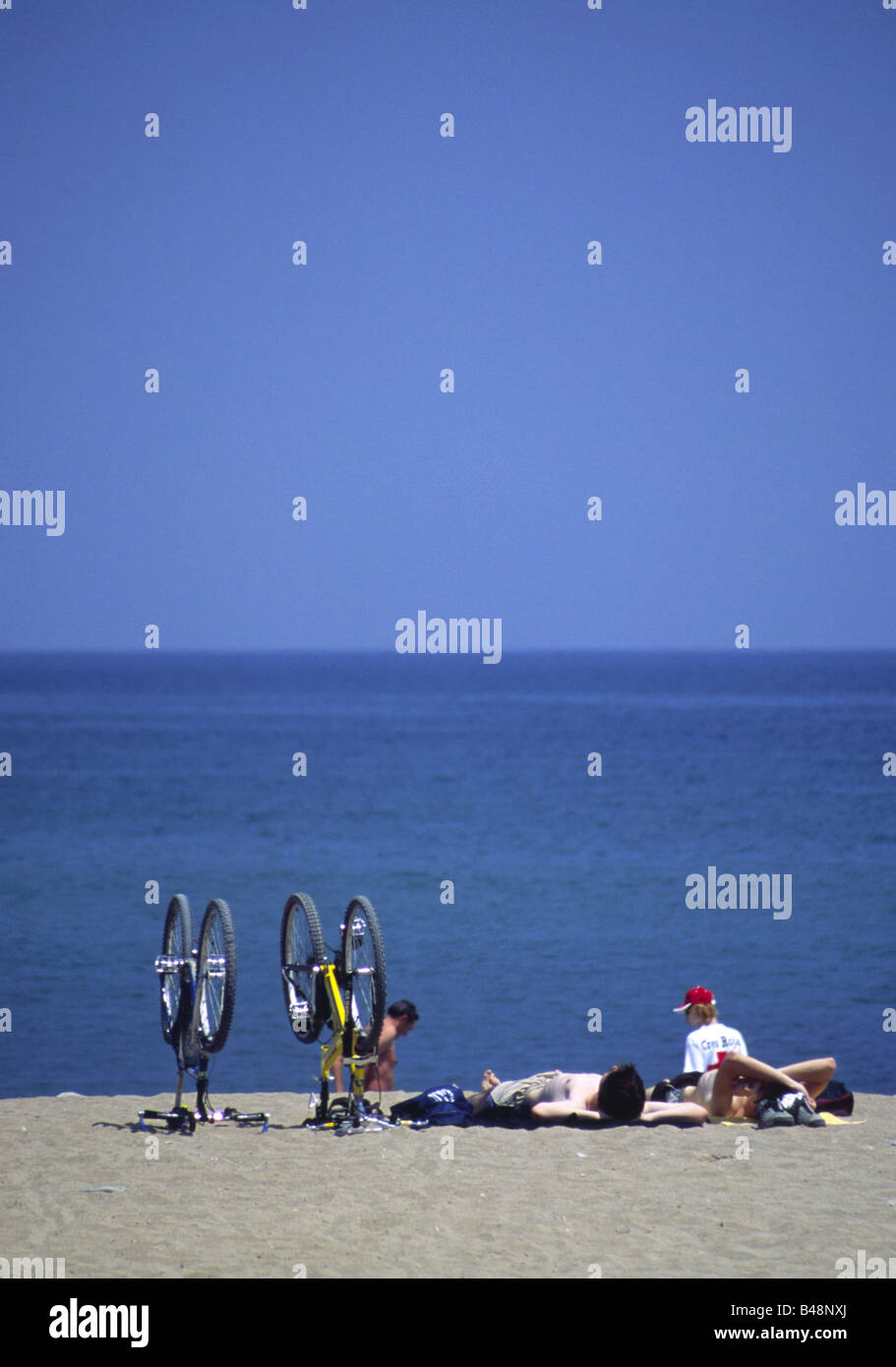 Two men sunbathing on beach hi-res stock photography and images - Alamy