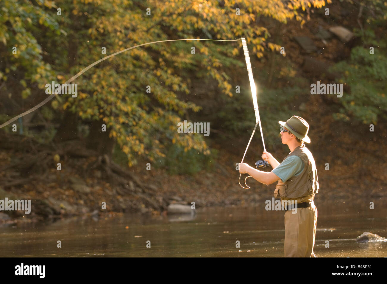 Man fly fishing on the river Stock Photo - Alamy