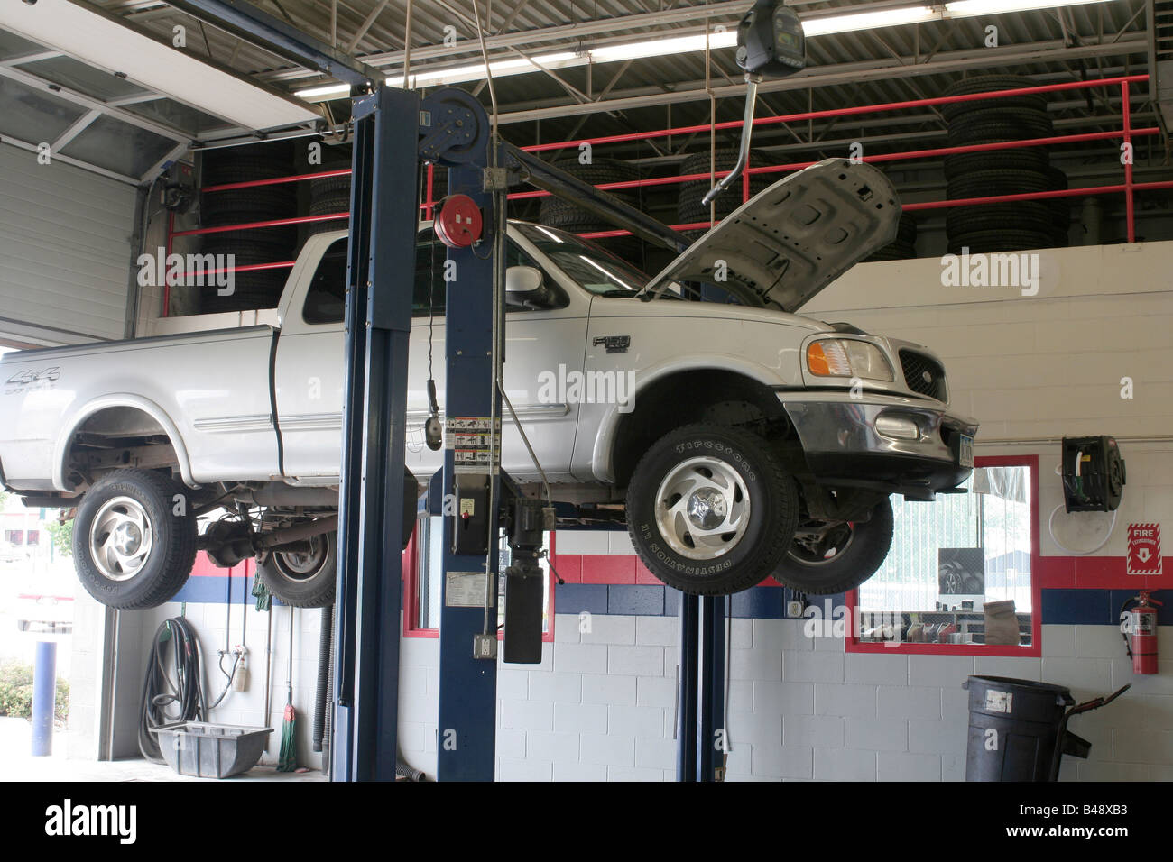 Pickup on lift in auto repair shop Stock Photo - Alamy