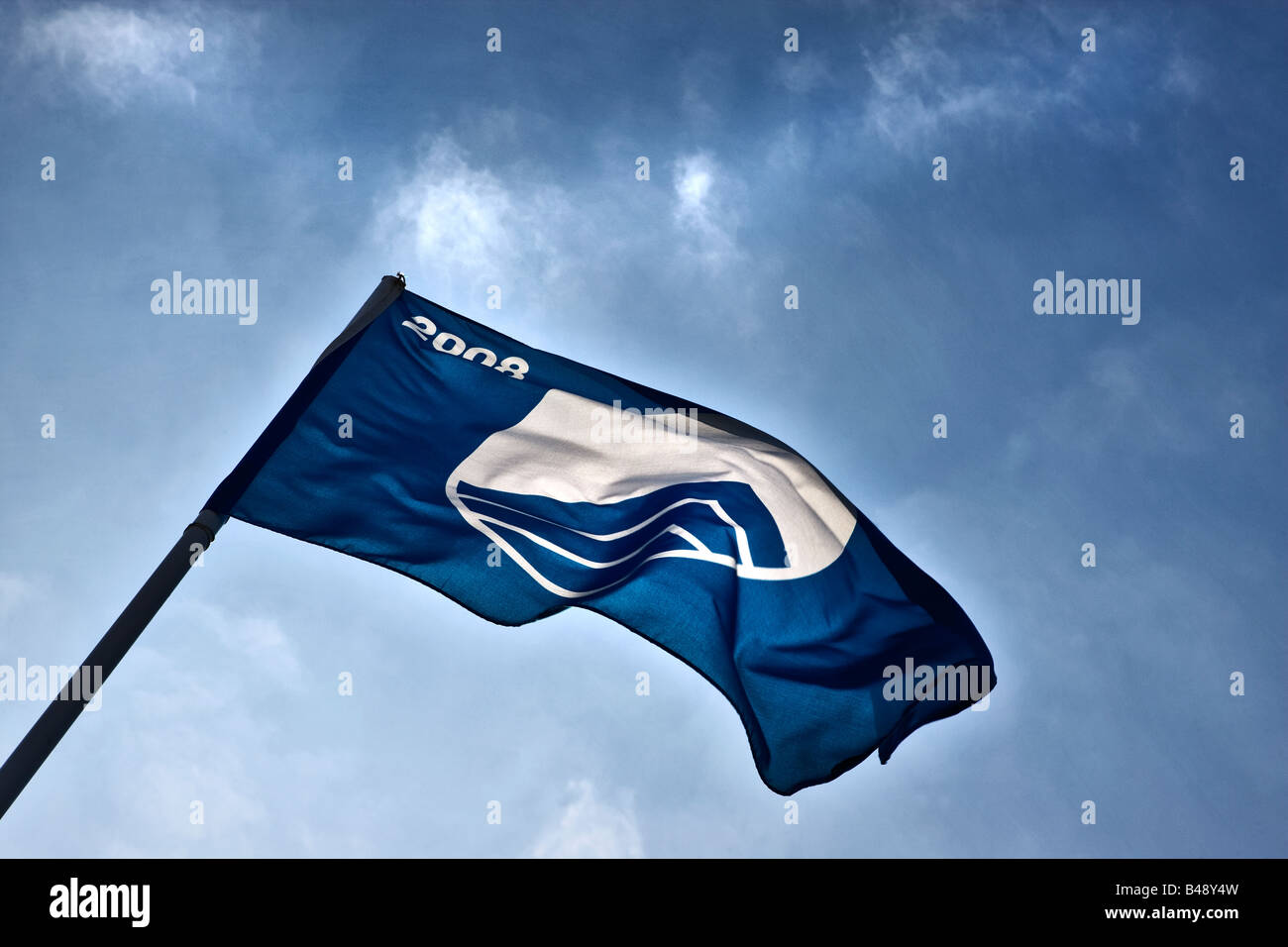 Clean beach blue flag against a blue sky; awarded to Cromer, Norfolk ...