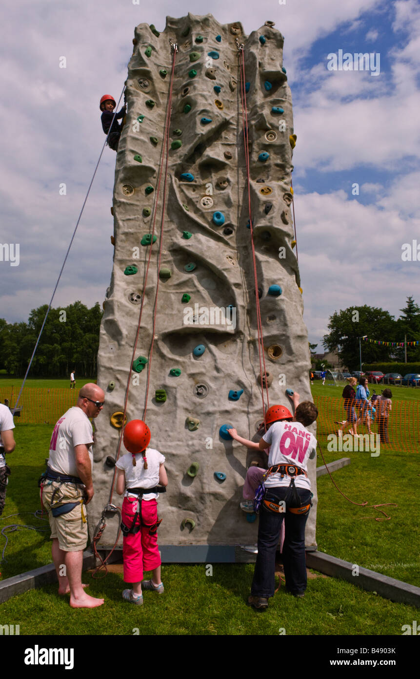 Children getting climbing lessons on practice wall Stock Photo - Alamy