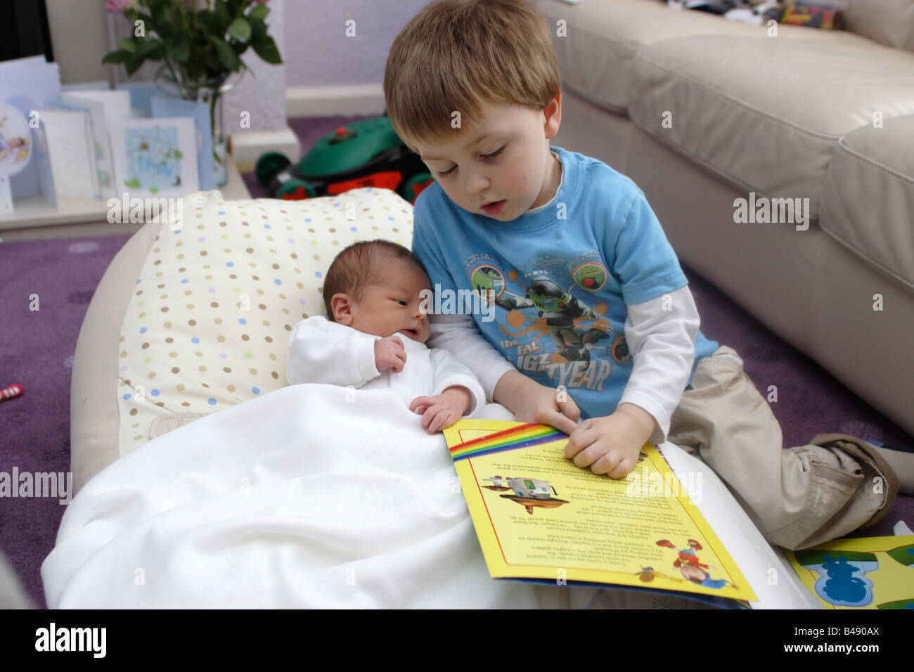 Boy reading a story to his baby brother Stock Photo - Alamy