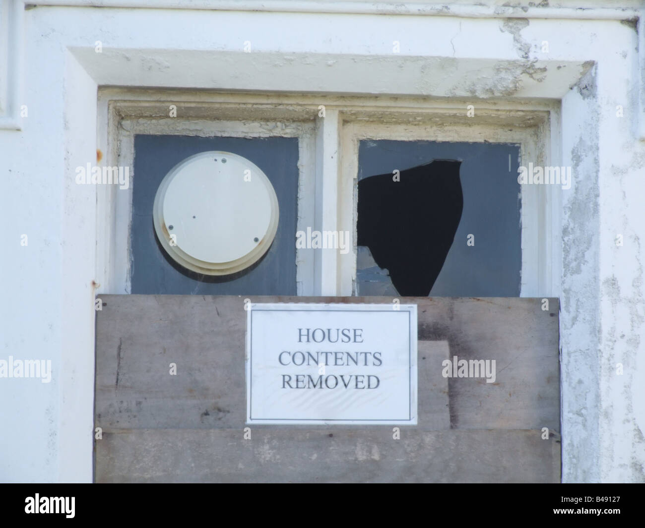 house contents removed sign on derelict property window Stock Photo - Alamy