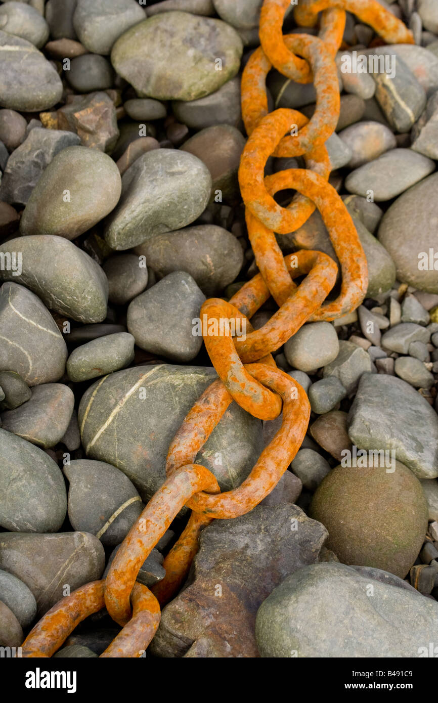 Rusty Chain and Pebbles Stock Photo - Alamy