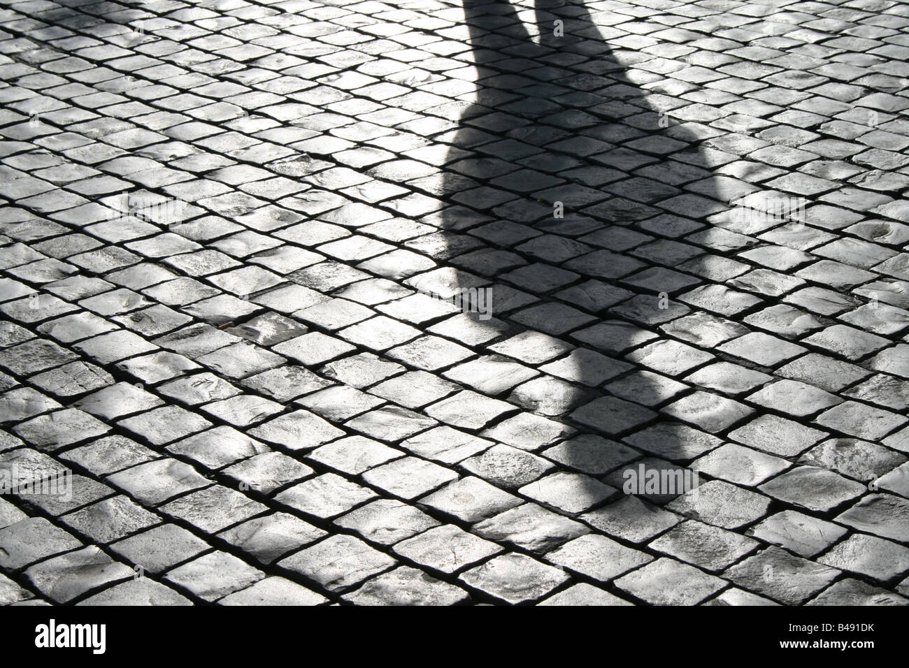 shadow of person on street road in city town Stock Photo - Alamy