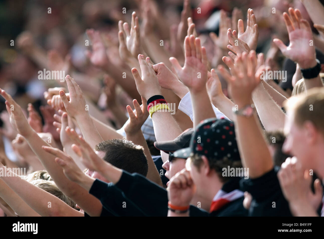 Soccer fans waving with their hands Stock Photo - Alamy