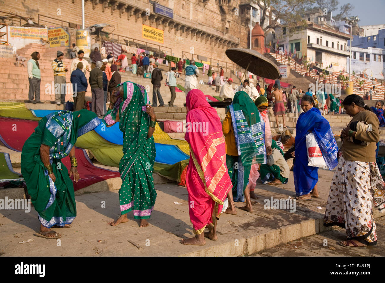Hindu women wear saris on the Man Mandir Ghat in the city of Varanasi ...