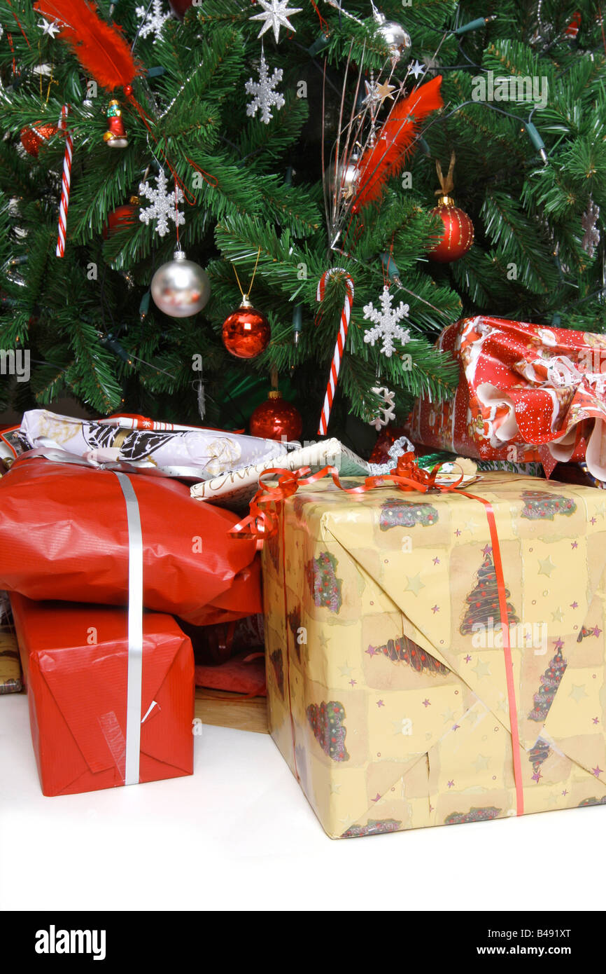 Presents of all sizes under a beautiful christmas tree Stock Photo - Alamy