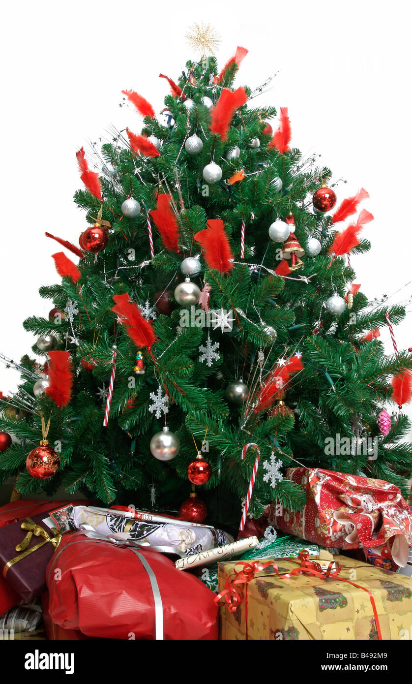 Presents of all sizes under a beautiful christmas tree Stock Photo - Alamy