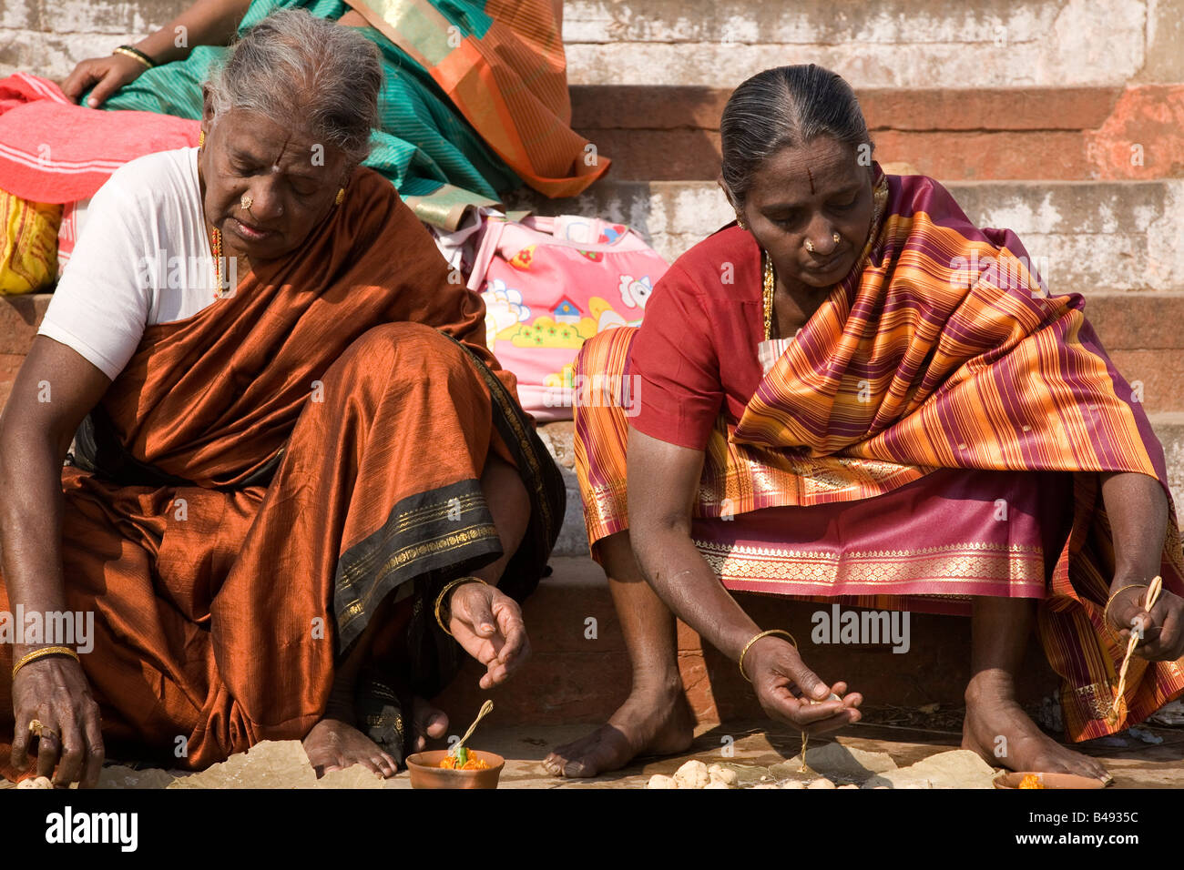 Female mourners participate in a puja in the city of Varanasi, India ...