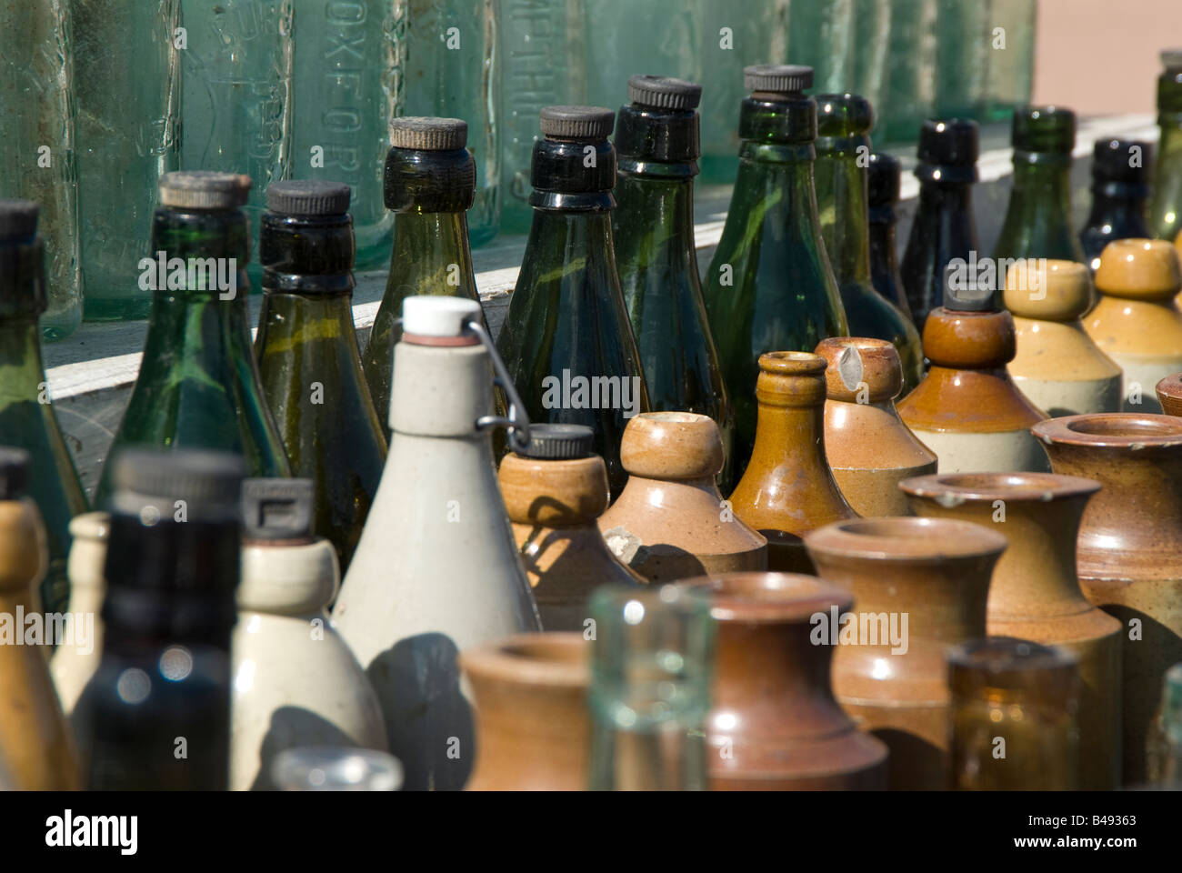 A collection of vintage bottles, pots and jars displayed by a collector ...