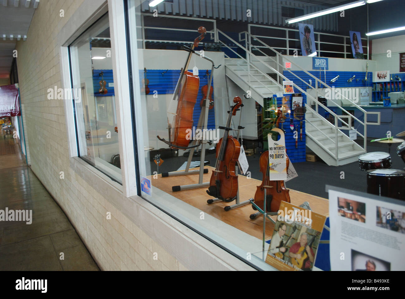 violins in music store window in mall hallway Stock Photo - Alamy