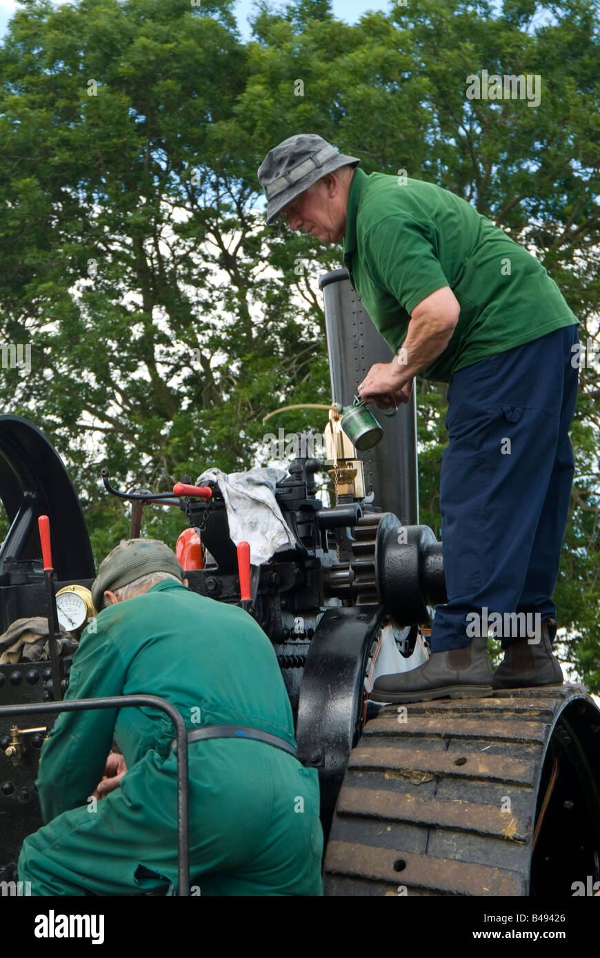 Two men oiling and maintaining a steam traction engine at Bloxham Steam ...