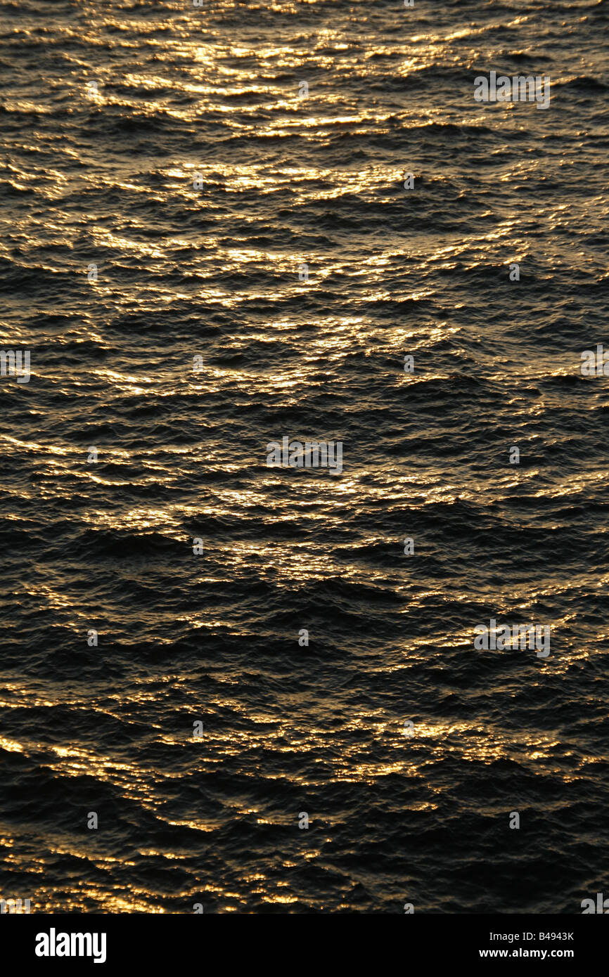 detail of pattern in waves in gold sea at sunset Stock Photo - Alamy