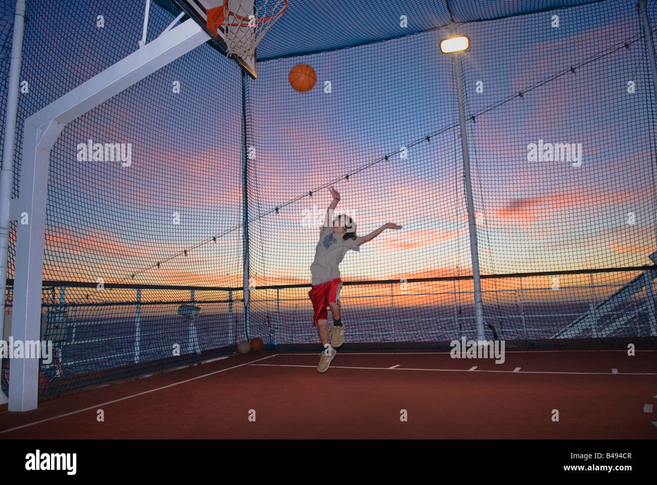 boy practicing basketball outdoors Stock Photo - Alamy