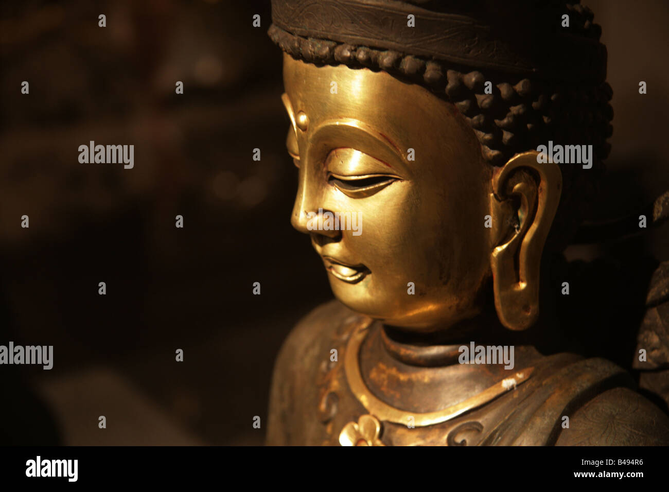 Gold painted Buddha staue showing face of Buddha Stock Photo - Alamy