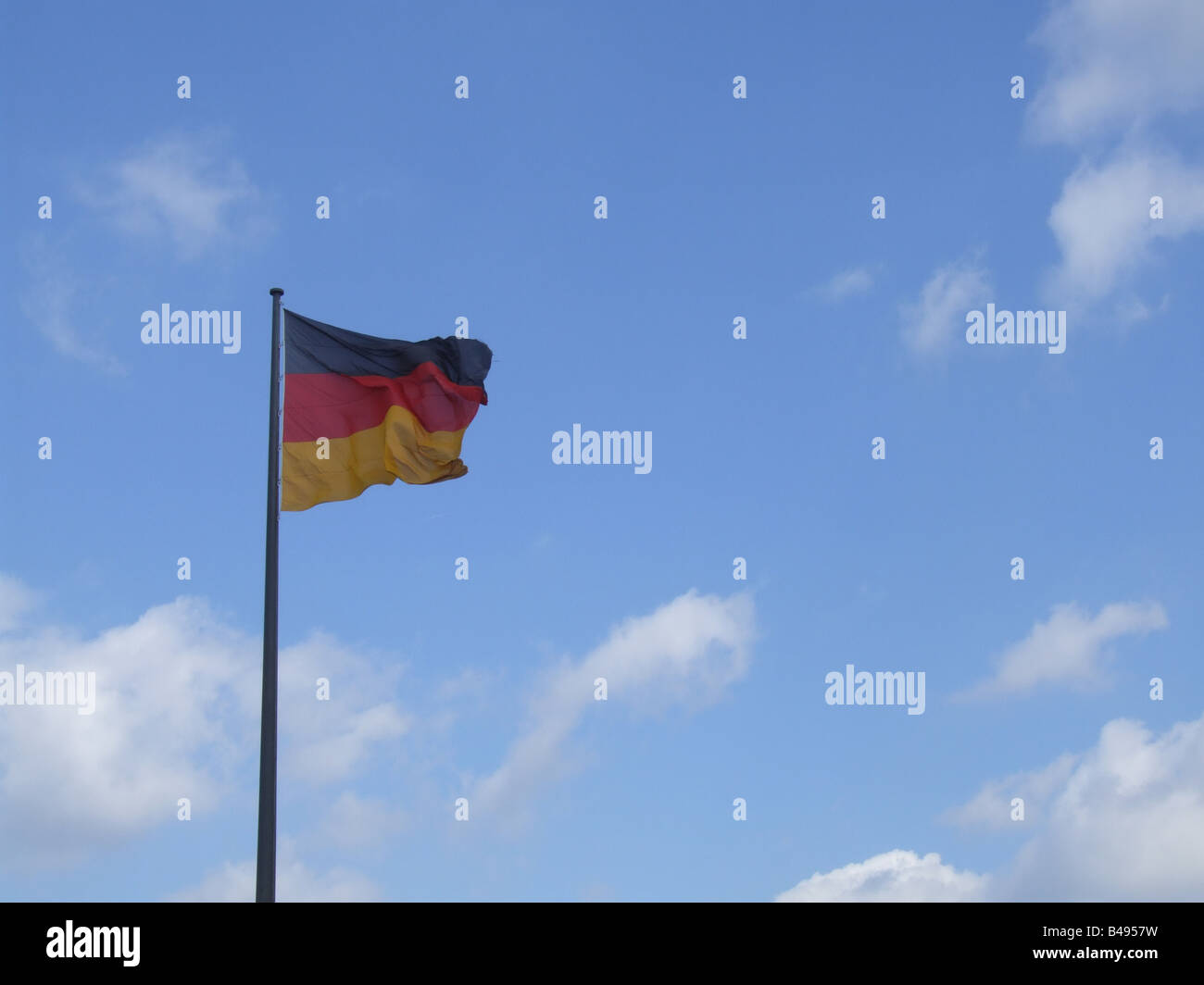 german flag flying in blue sky in berlin Stock Photo - Alamy