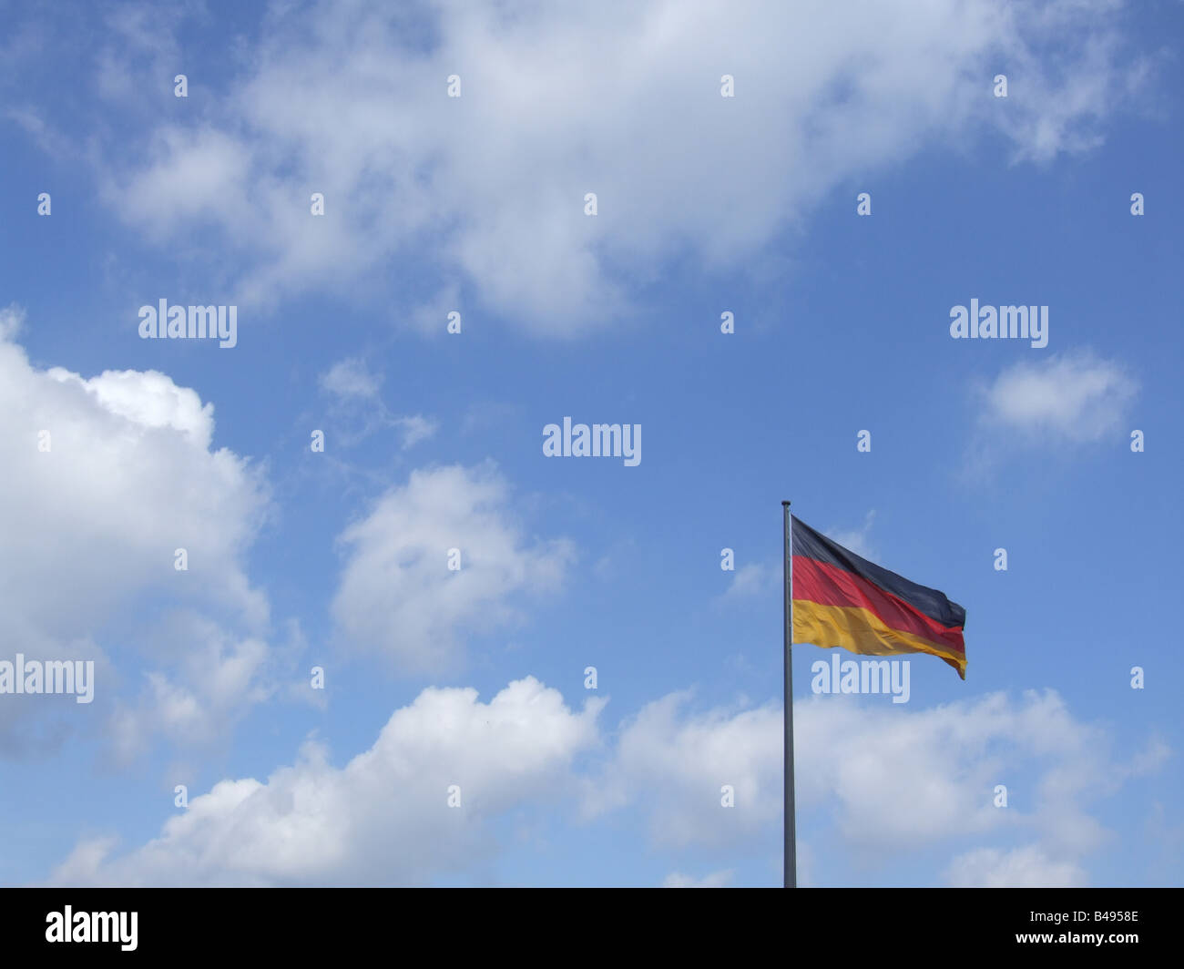 german flag flying in blue sky in berlin Stock Photo - Alamy