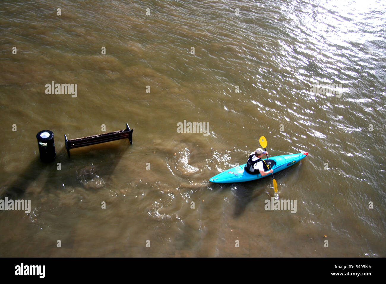 Man paddling down the pavement in a canoe Stock Photo - Alamy