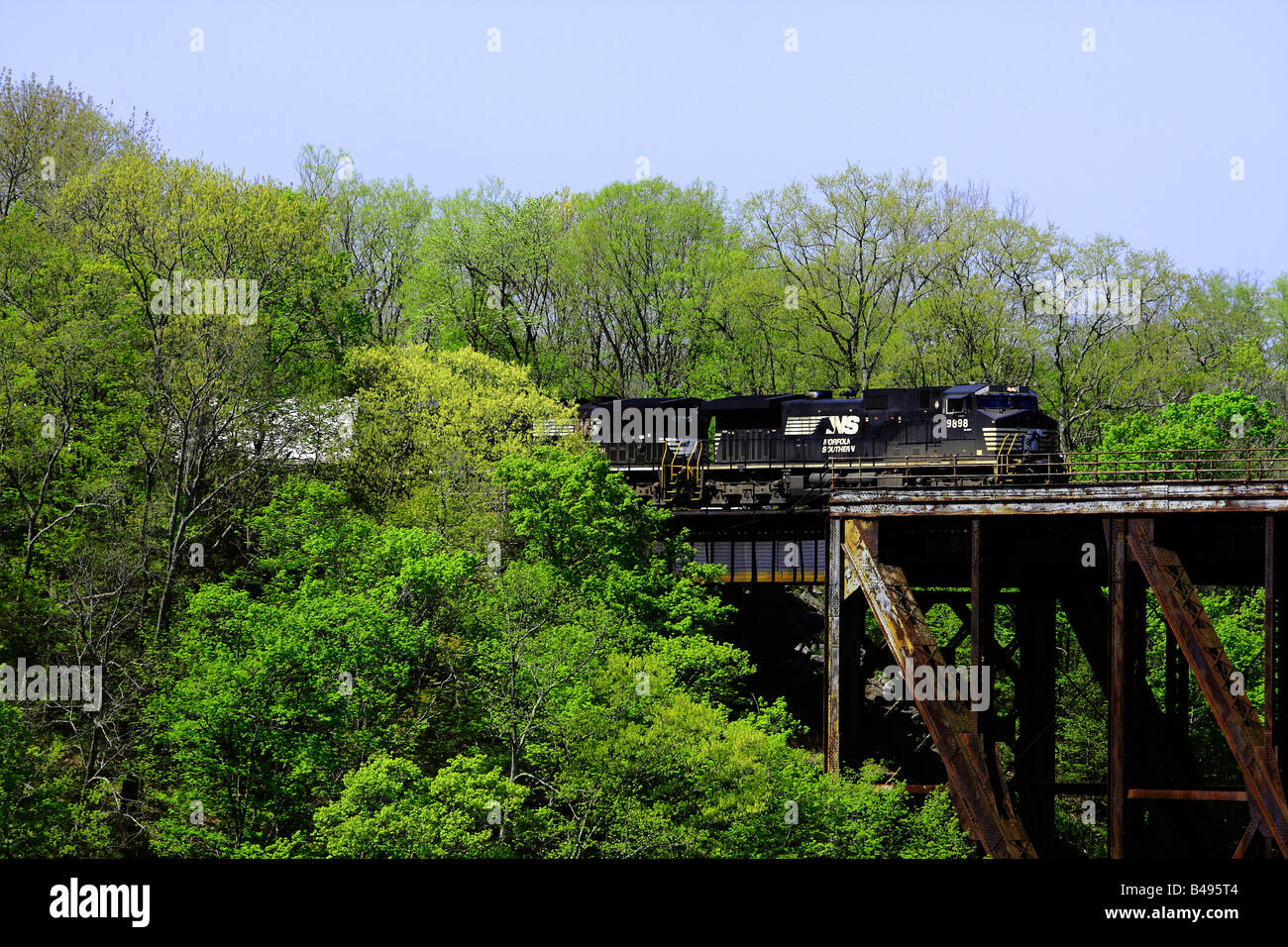 Freight train starting to cross highbridge Stock Photo - Alamy
