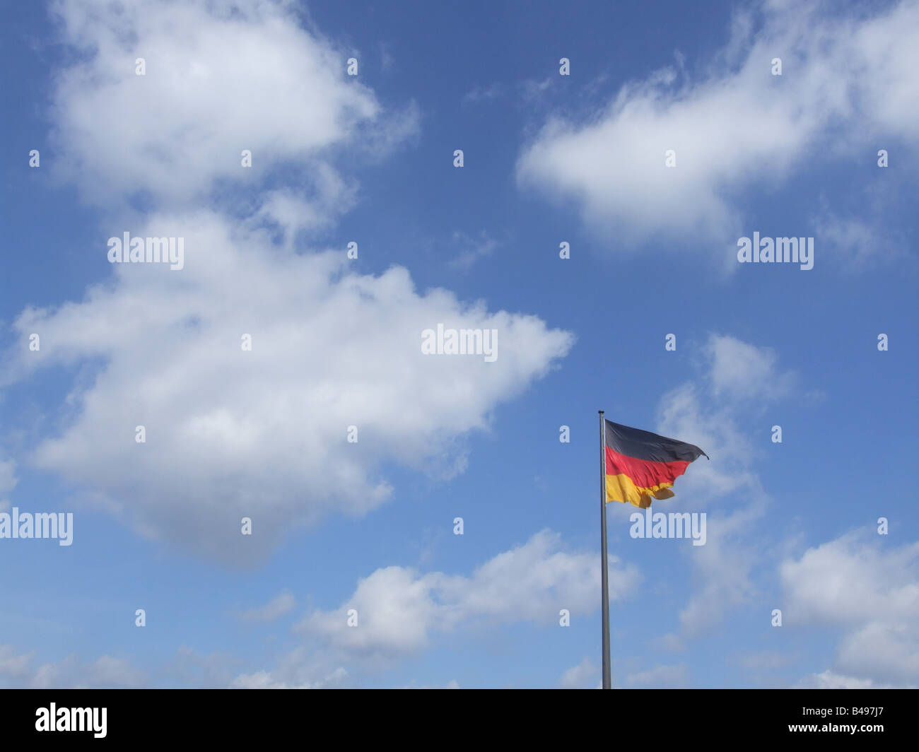 german flag flying in blue sky in berlin Stock Photo - Alamy