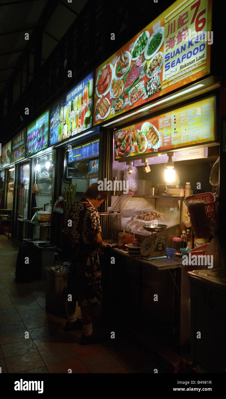A man studies a menu at Newton Circus Hawker Centre Stock Photo - Alamy