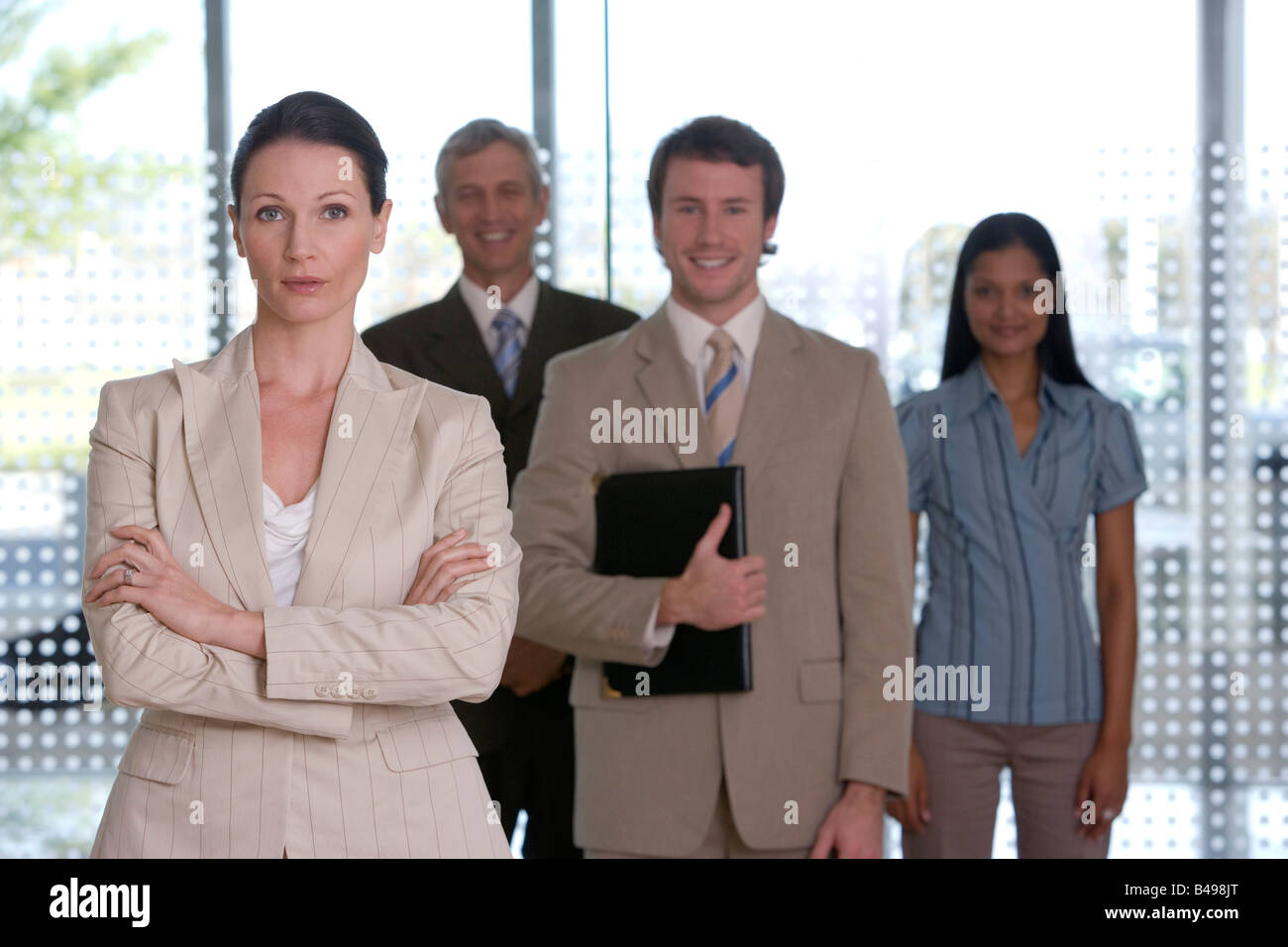 Businesswoman with team behind Stock Photo - Alamy