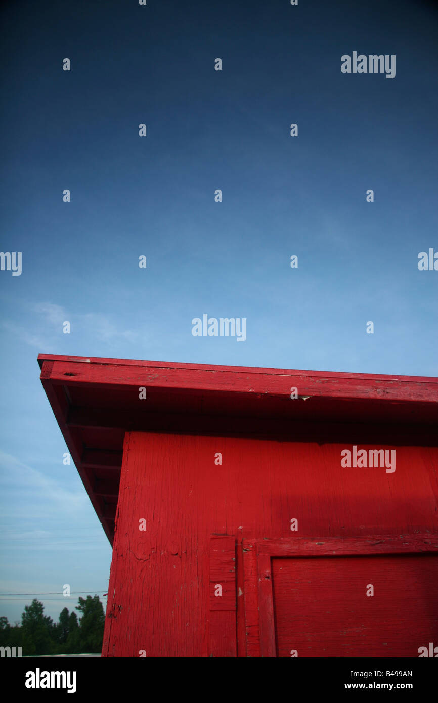 View of the upper corner of a red wooden building against a beautiful ...
