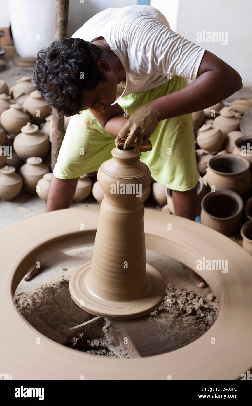 Traditional village Indian potters livelihood, throwing pots out of one ...
