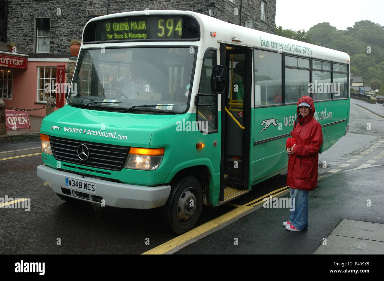 woman standing at bus stop, Boscastle, Cornwall, England, UK Stock ...