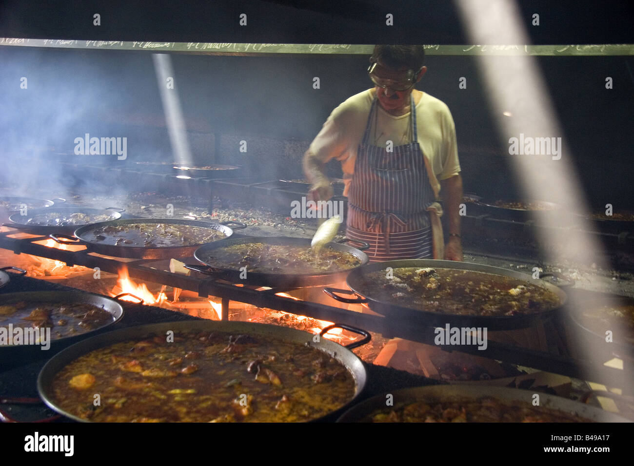 Male cook cooking paella typical spanish dish Valencia Spain Stock ...