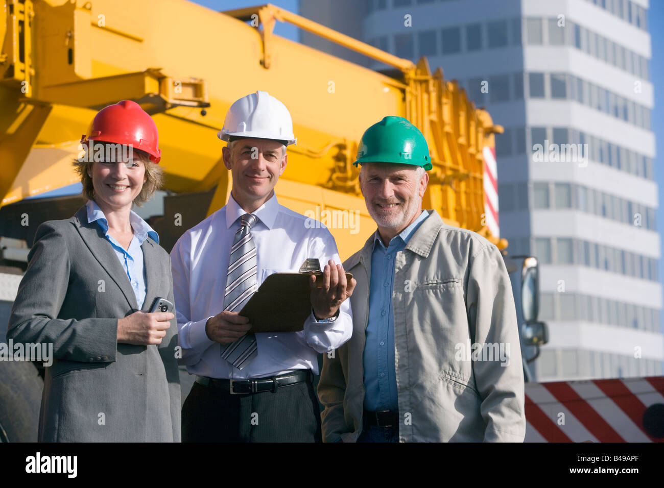Three construction engineers on survey Stock Photo - Alamy