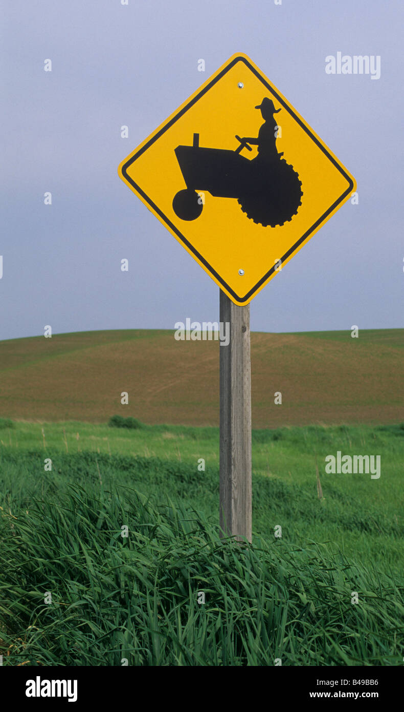 Road sign cautioning tractor crossing Stock Photo - Alamy
