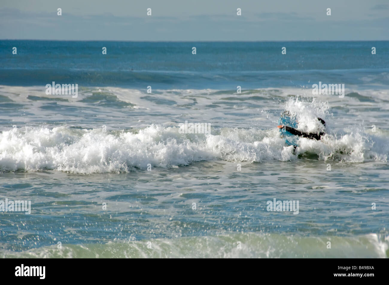Rough start -- surfer seemingly overwhelmed in a shallow wave Stock ...