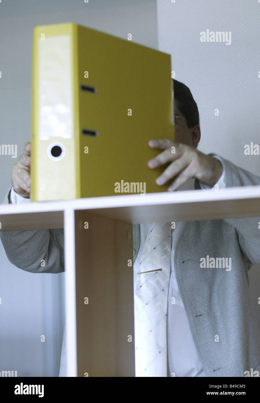 Man with a file binder Stock Photo - Alamy